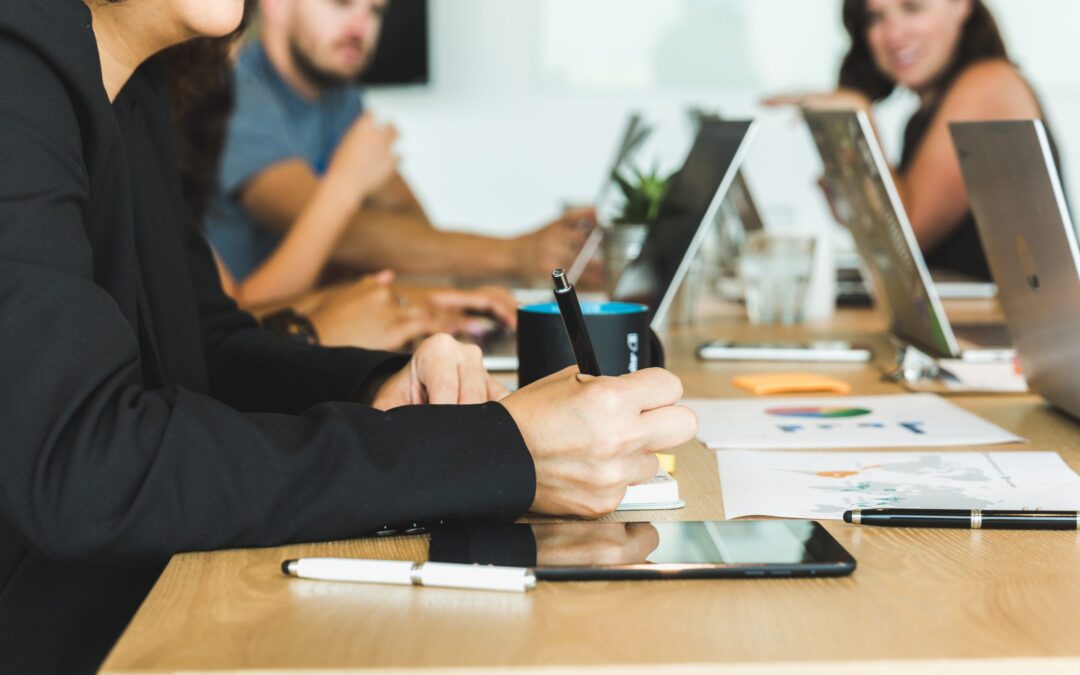 woman-taking-notes-during-team-meeting - Journey Point